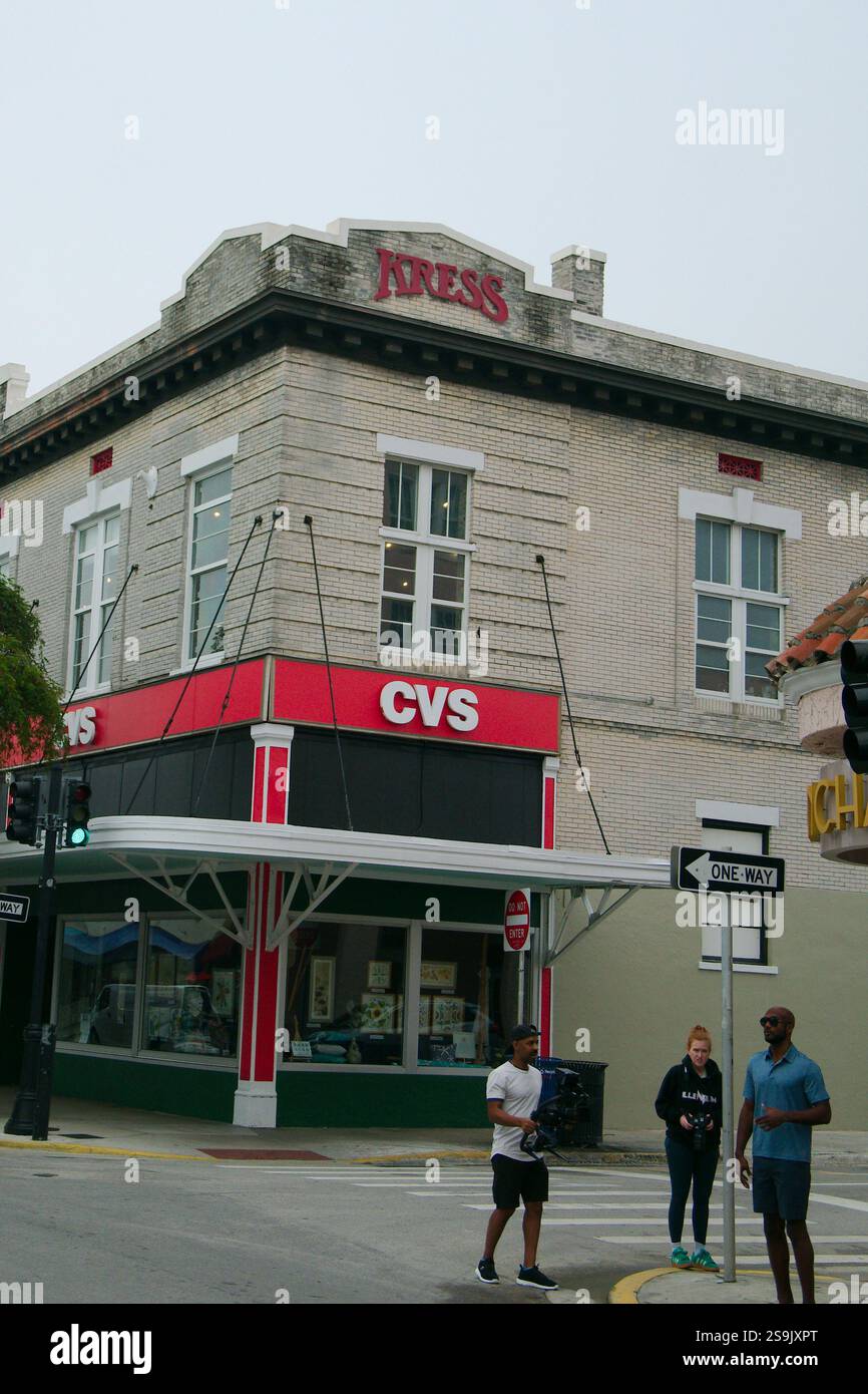 Small three person film crew, video camera man, woman taking pictures ...