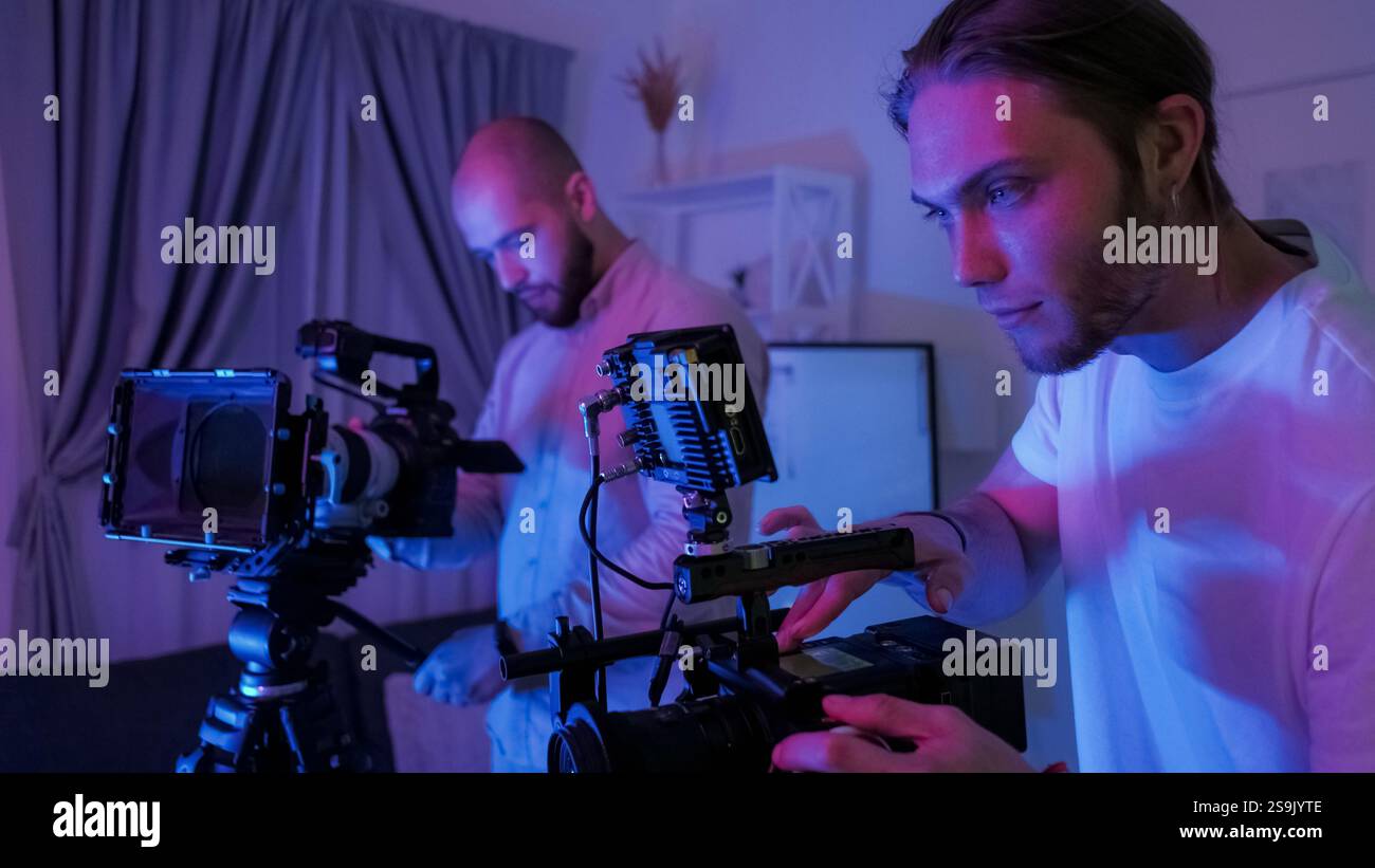 Cameraman backstage. Behind scene. Male videographer looks digital ...