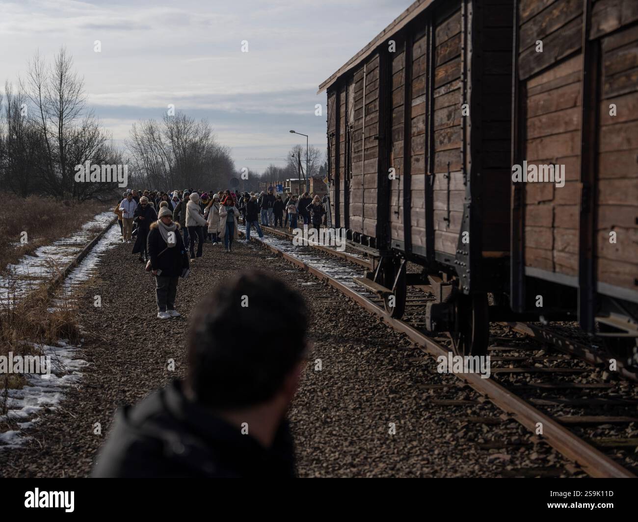 People visit railroad tracks and a carriage used for prisoner ...