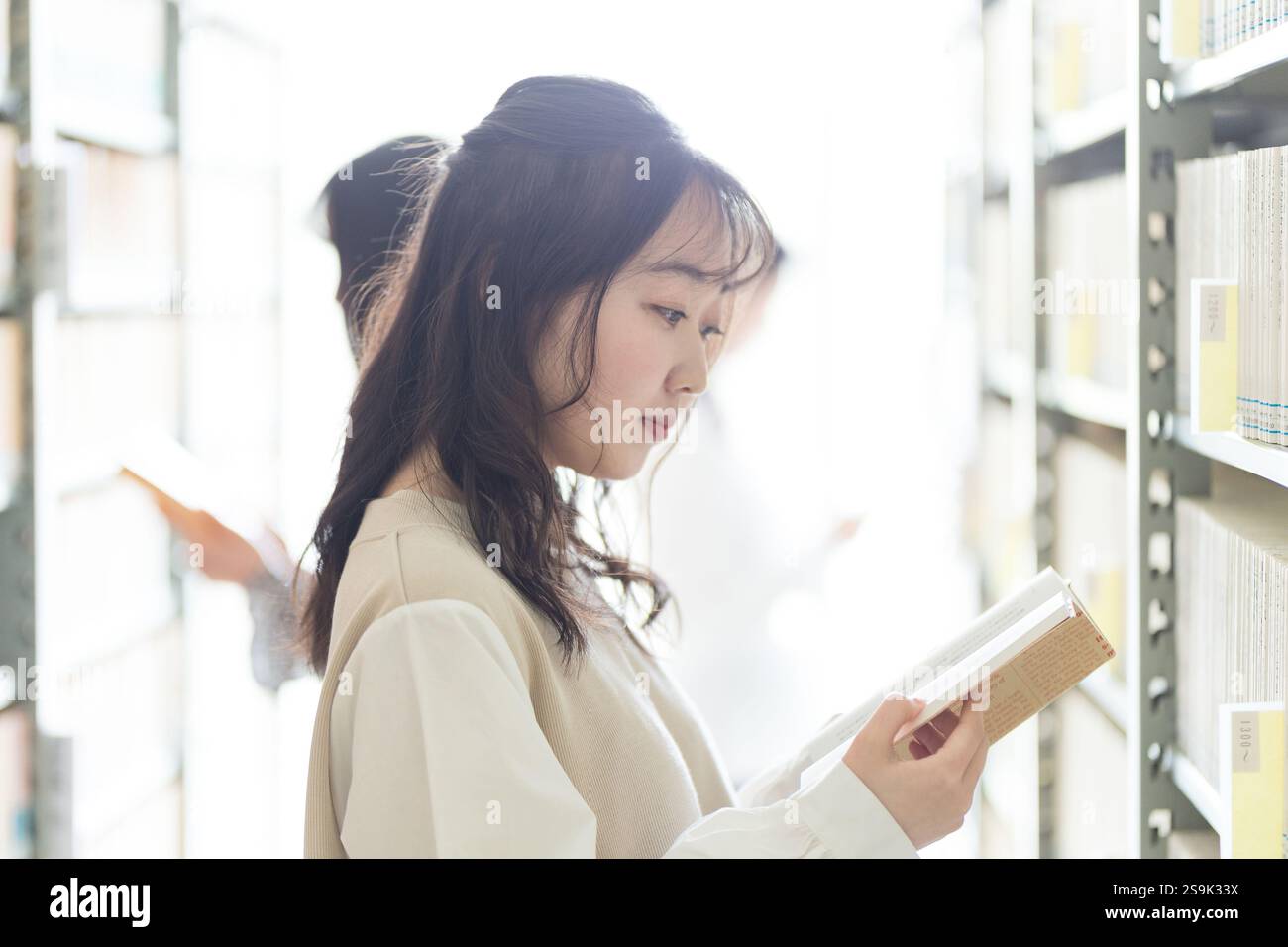 University student choosing a book Stock Photo - Alamy