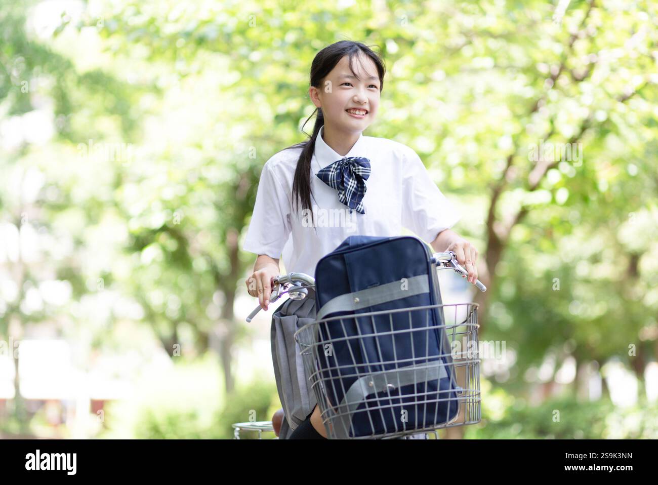 Junior high school student riding a bicycle Stock Photo - Alamy