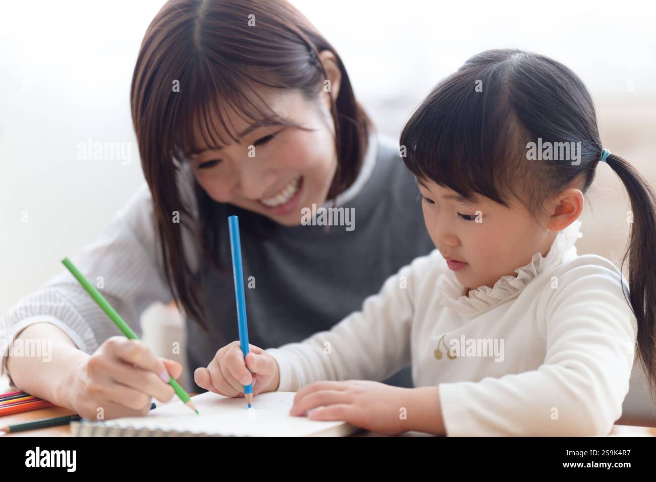 Parent and child drawing Stock Photo - Alamy