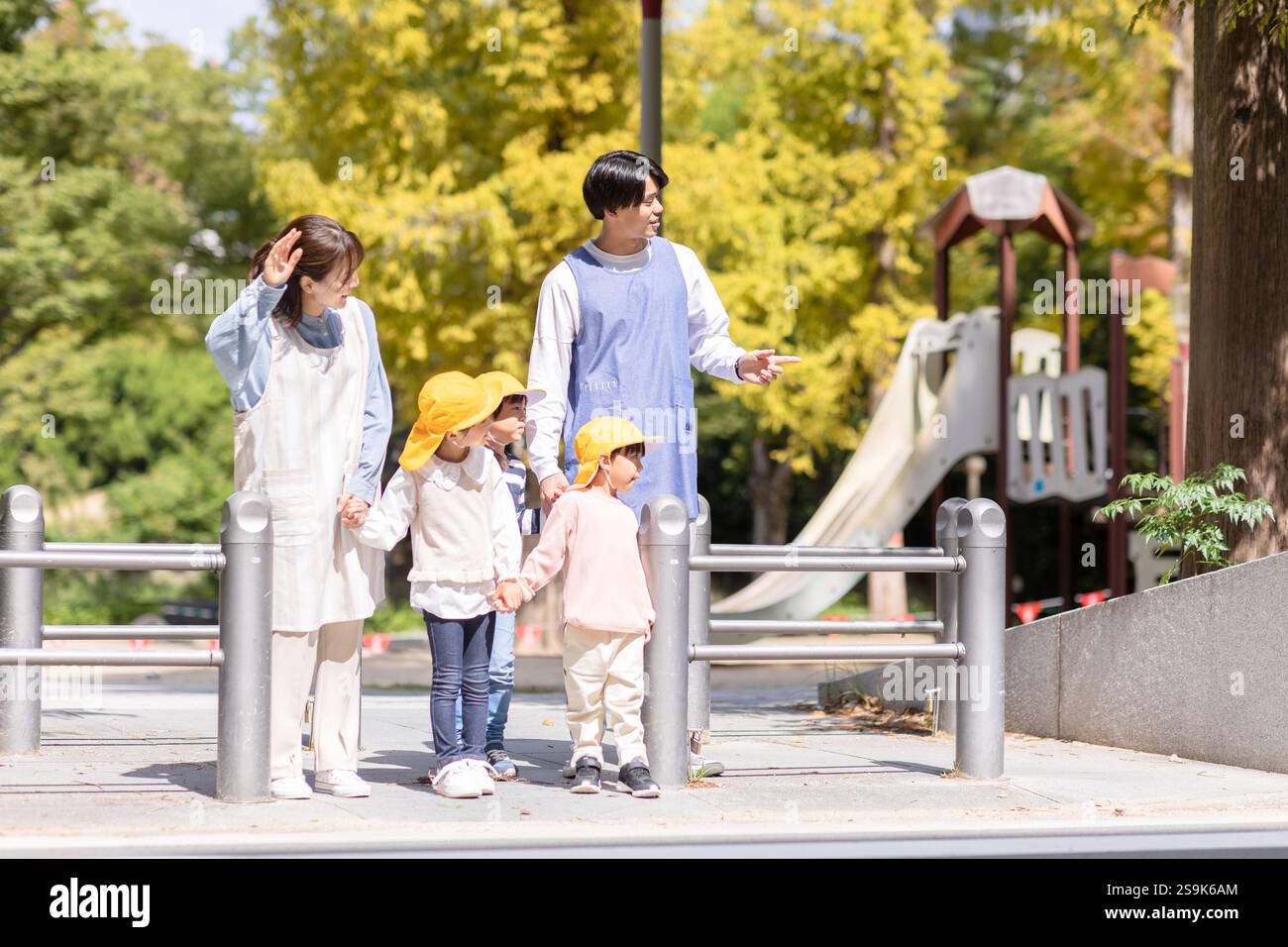 Nursery school teacher and children taking a walk Stock Photo - Alamy