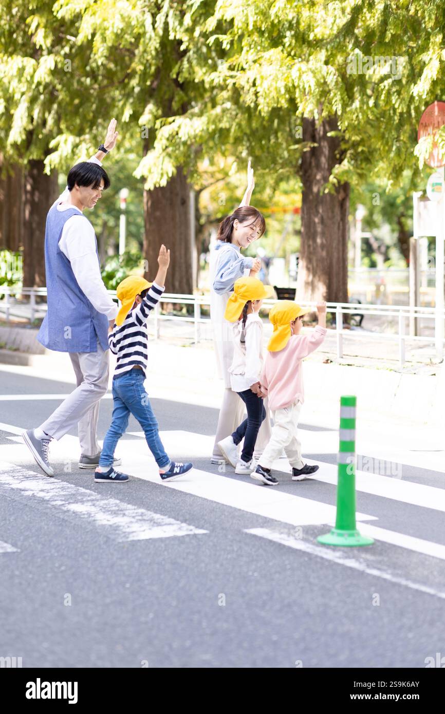 Nursery school teacher and children taking a walk Stock Photo - Alamy