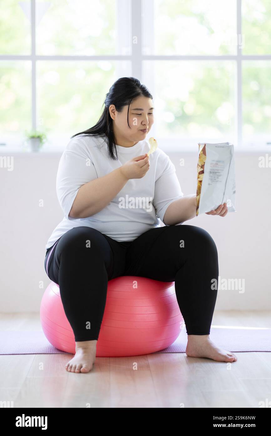 Women eating snacks Stock Photo - Alamy