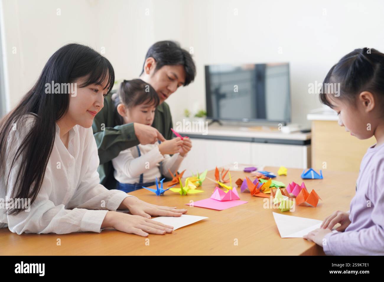 Family folding origami Stock Photo - Alamy