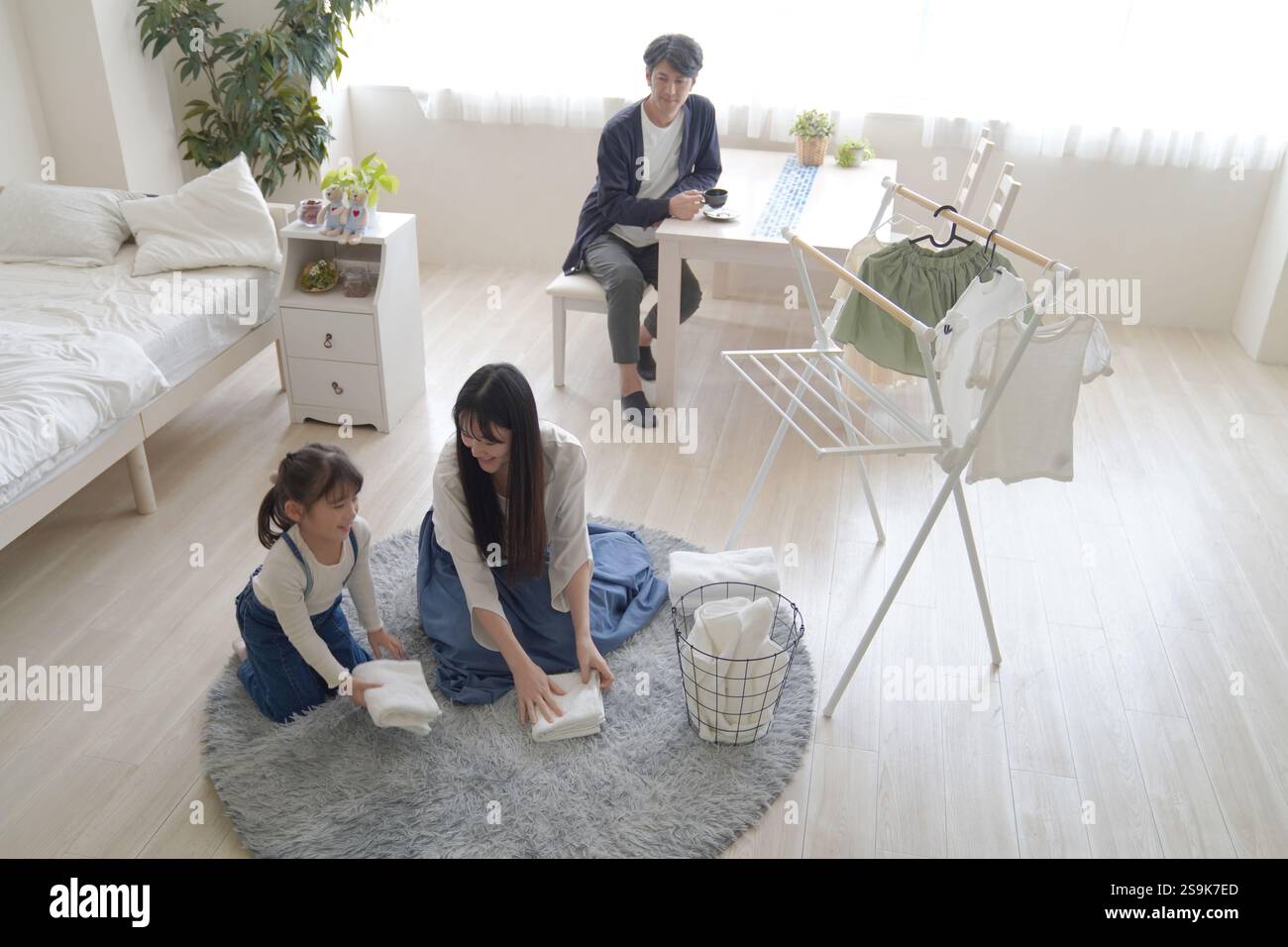 Parent and child drying laundry Stock Photo - Alamy