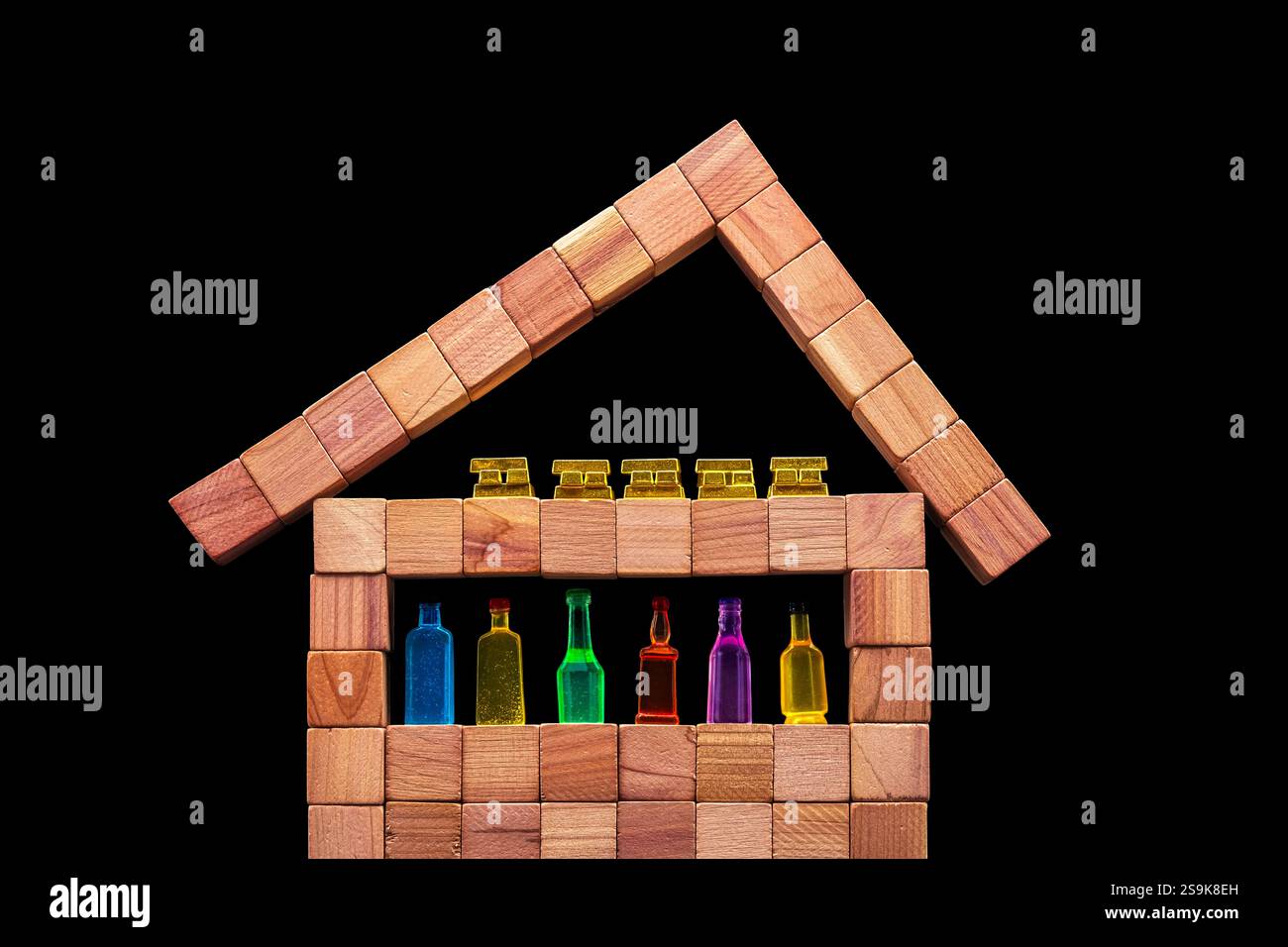 Wooden cubes arranged to form a simplistic house with various miniature ...