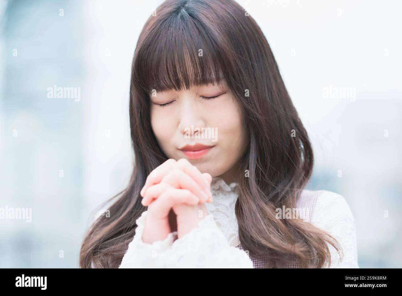 Woman in prayer pose Stock Photo - Alamy