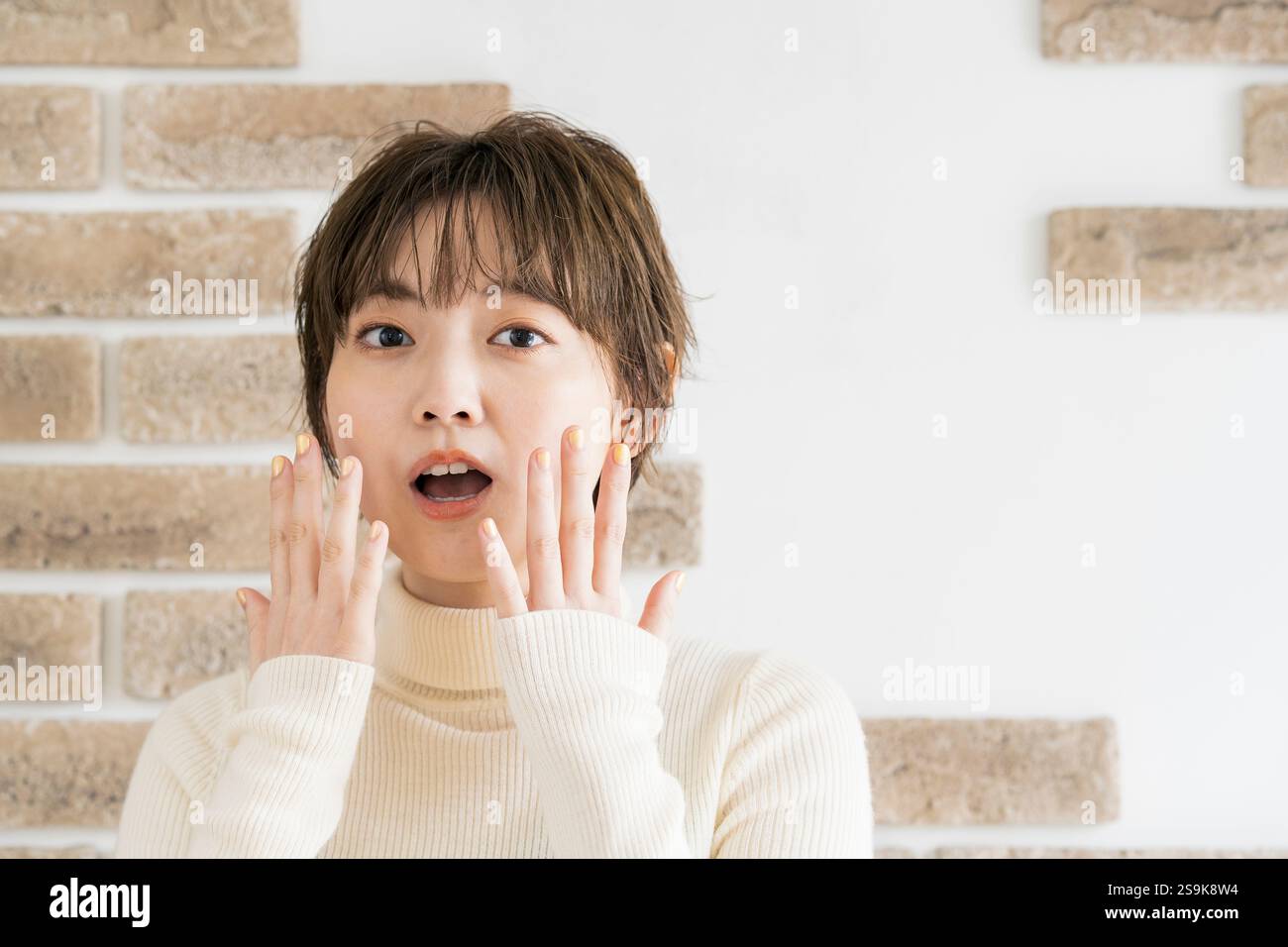 Young woman doing surprise pose with both hands Stock Photo - Alamy