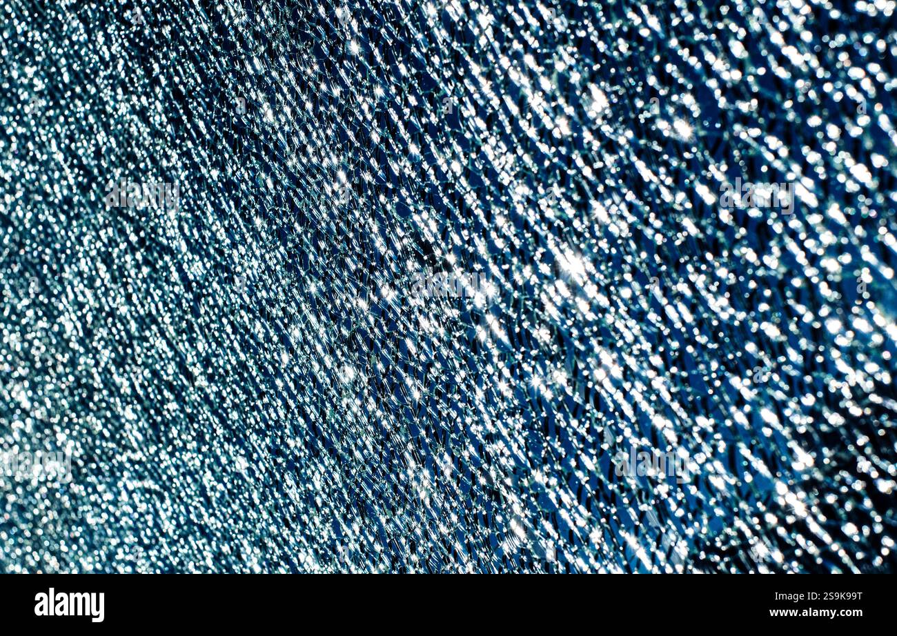 Broken safety laminated glass window following an act of vandalism ...