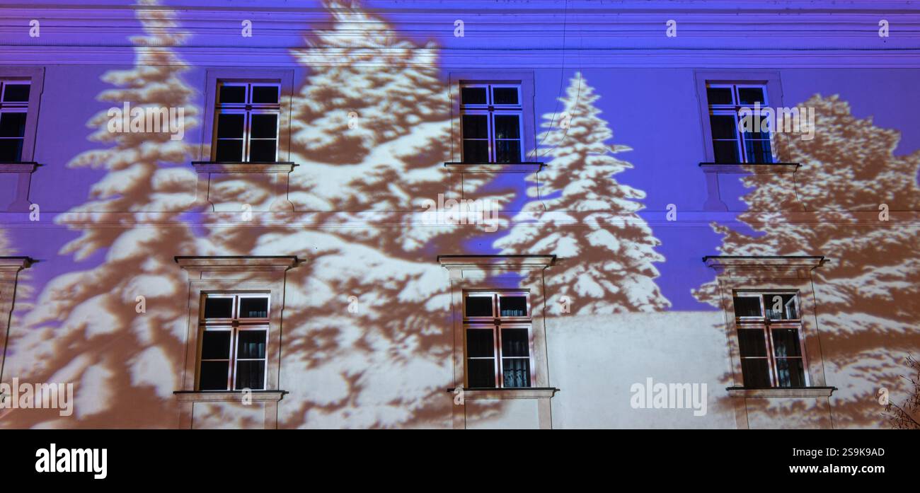 Christmas video projection on old building wall at night Stock Photo ...