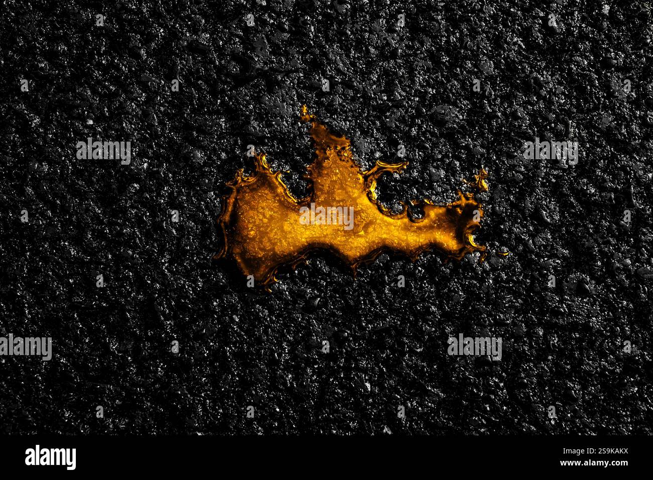 Liquid Golden Spill on Dark Asphalt Surface Stock Photo - Alamy
