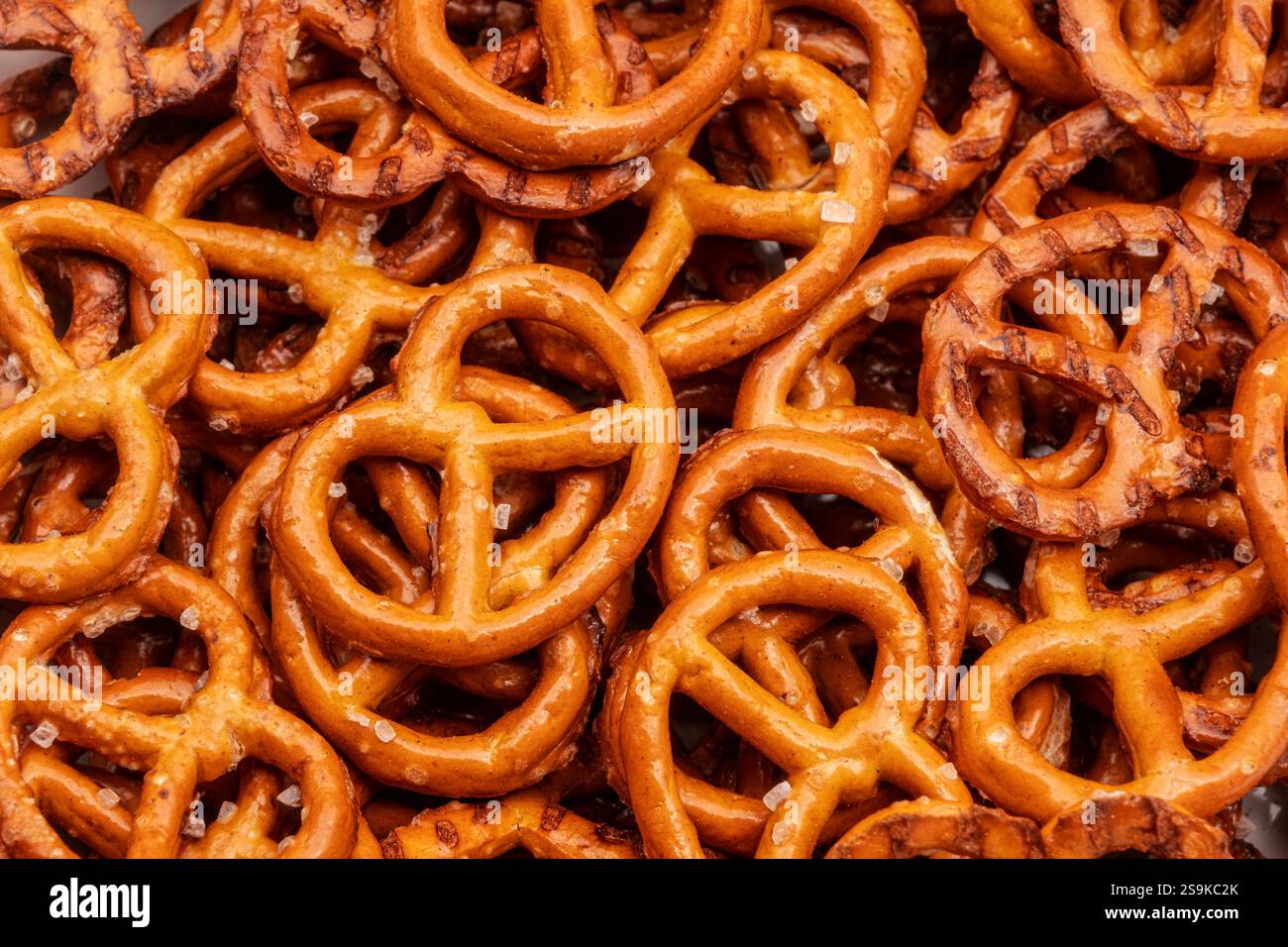 Salt pretzels, top view, full frame Stock Photo - Alamy