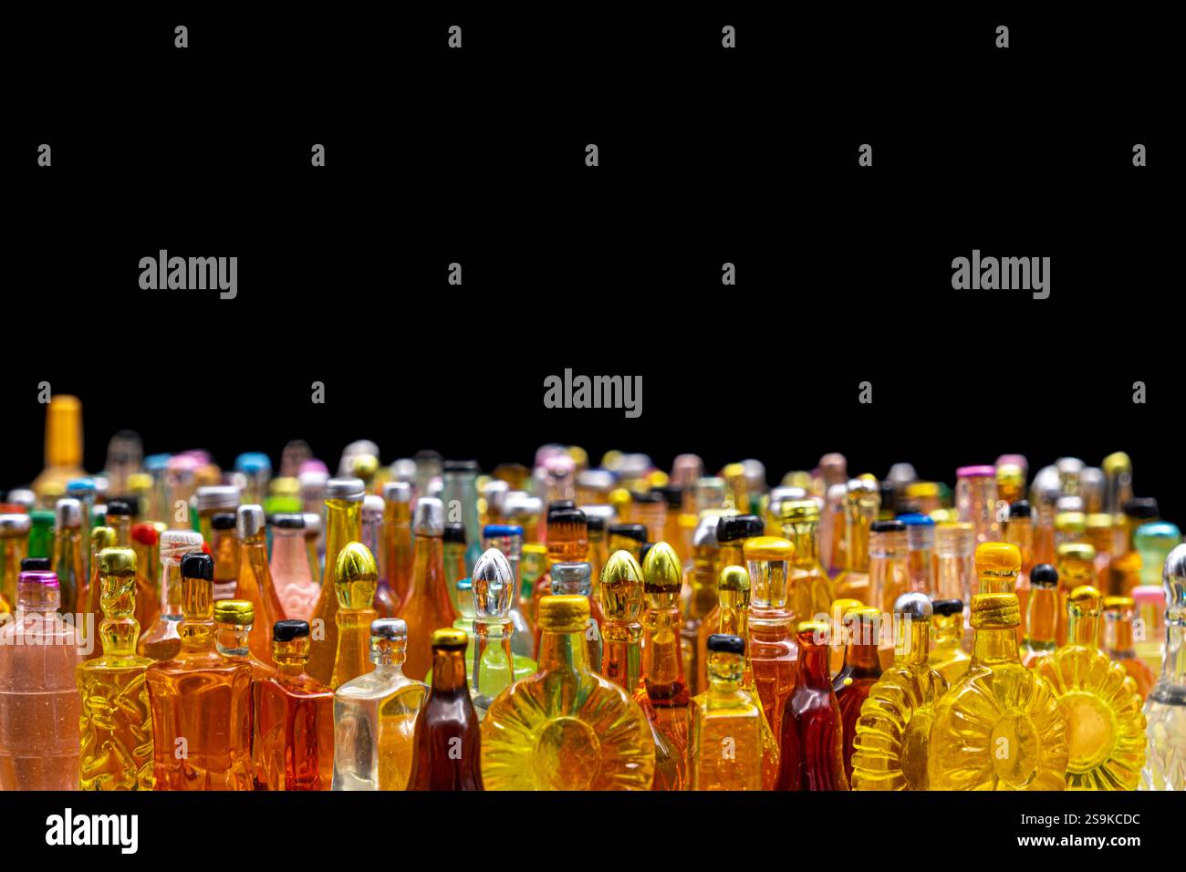 various miniature bottles of alcohol without labels with black ...