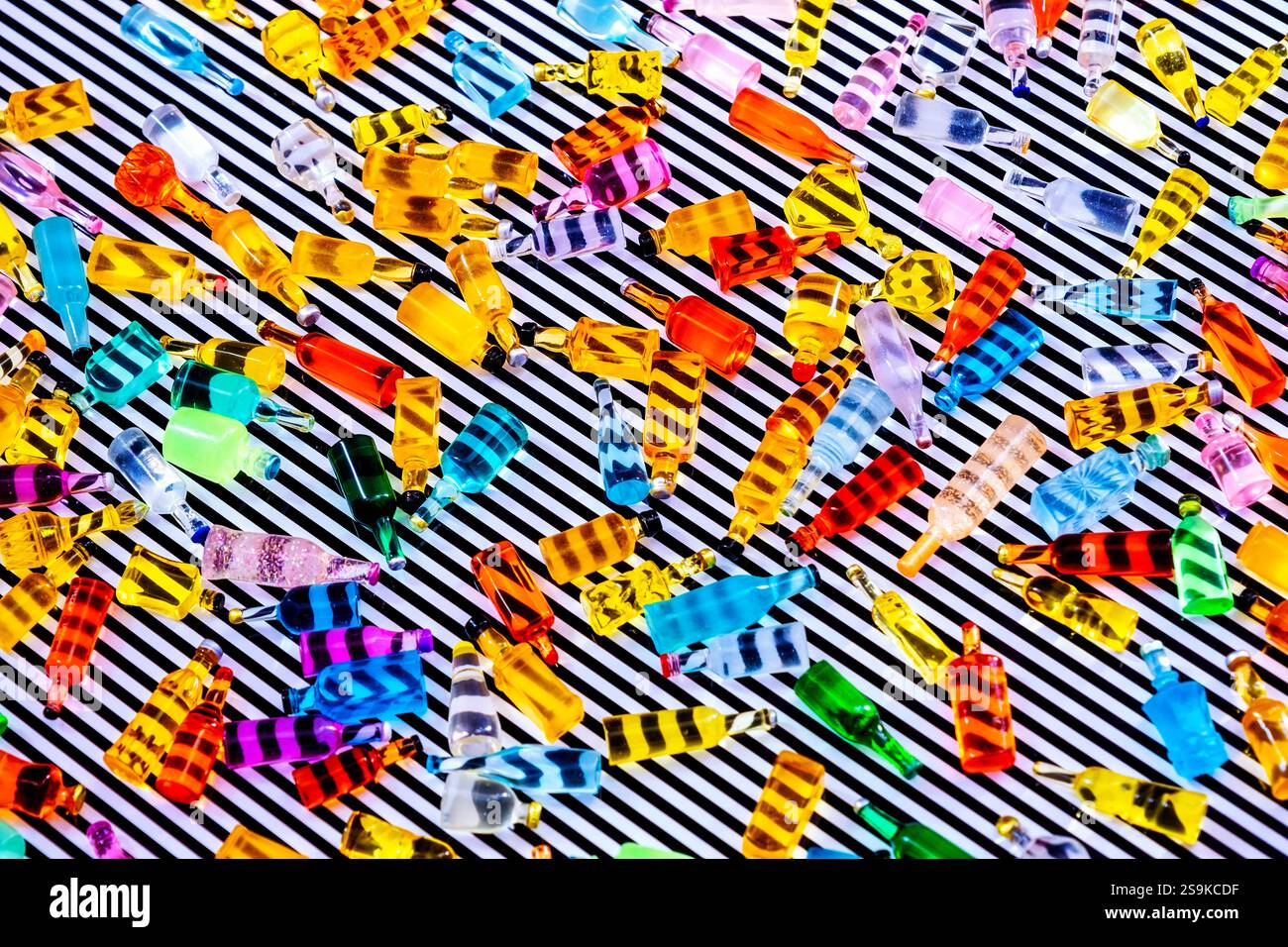 various miniature bottles of alcohol without labels on a hypnotic black ...