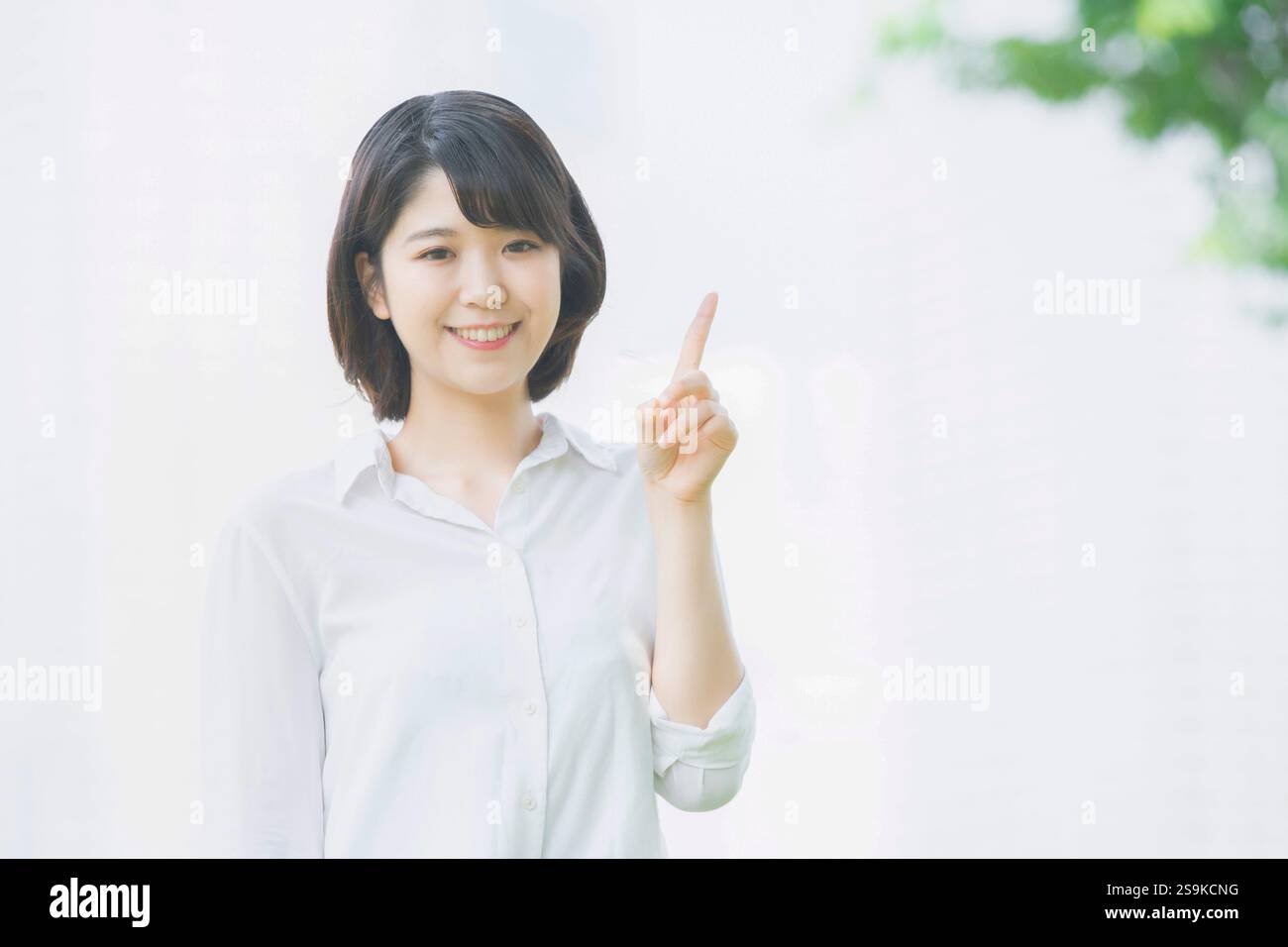 Woman holding up index finger Stock Photo - Alamy