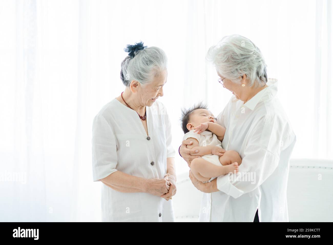 Senior women carrying babies Stock Photo - Alamy