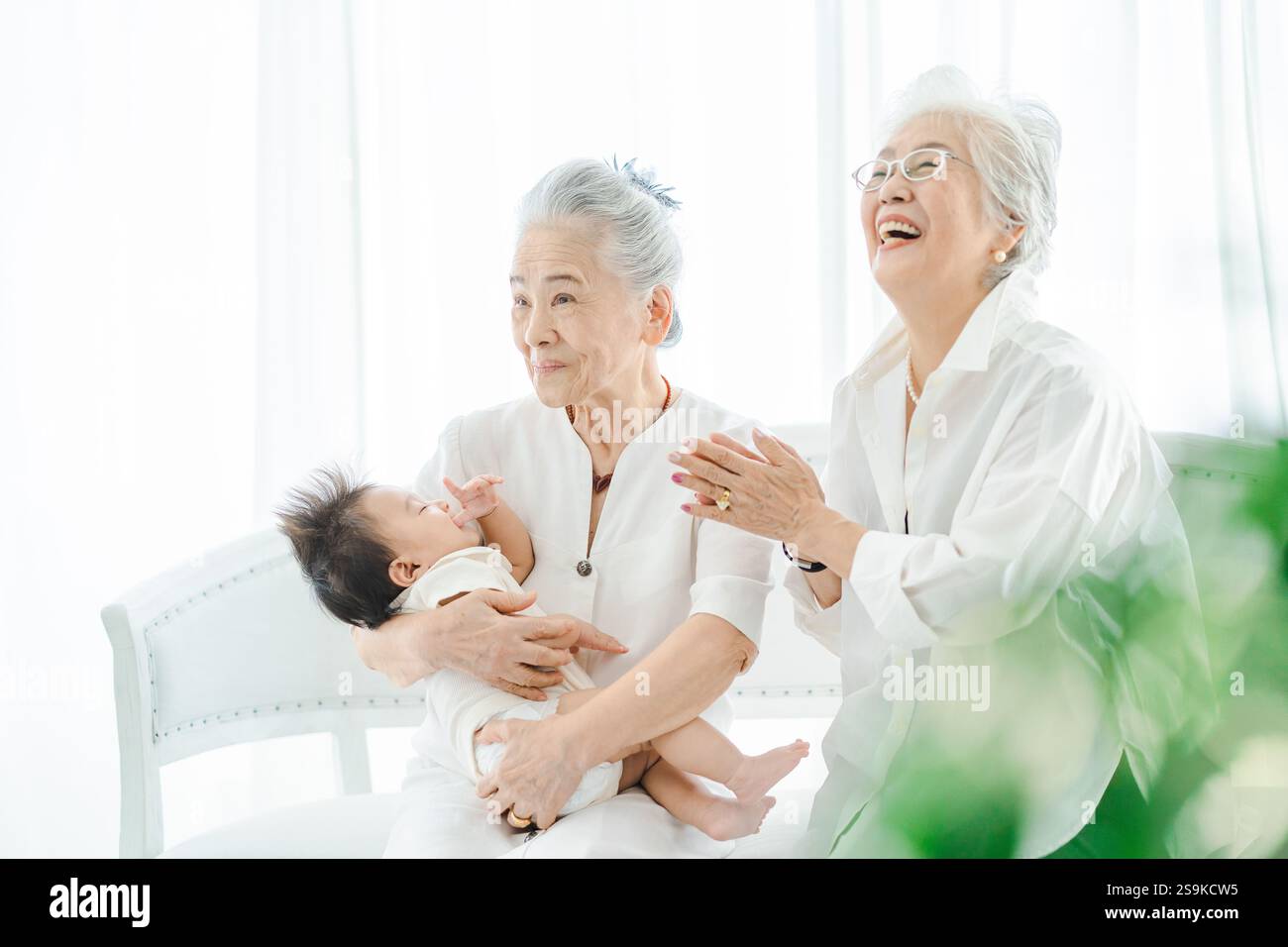 Senior women carrying babies Stock Photo - Alamy