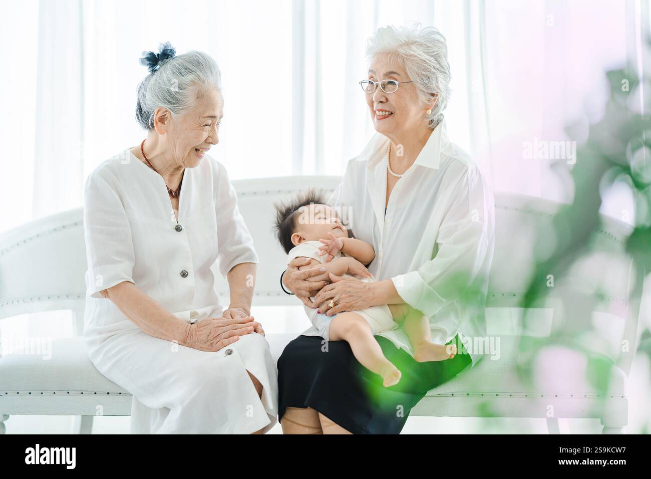 Senior women carrying babies Stock Photo - Alamy