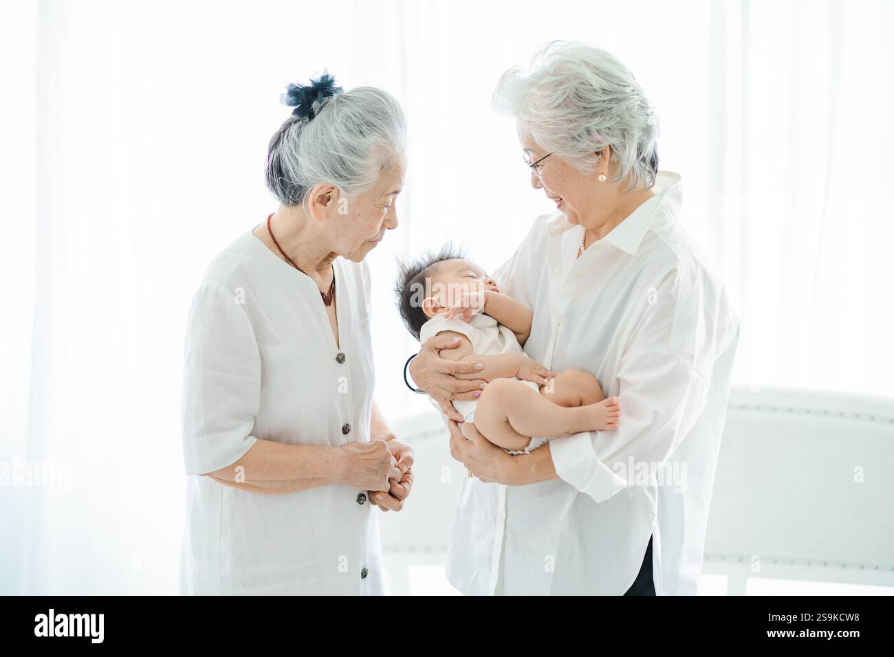 Senior women carrying babies Stock Photo - Alamy