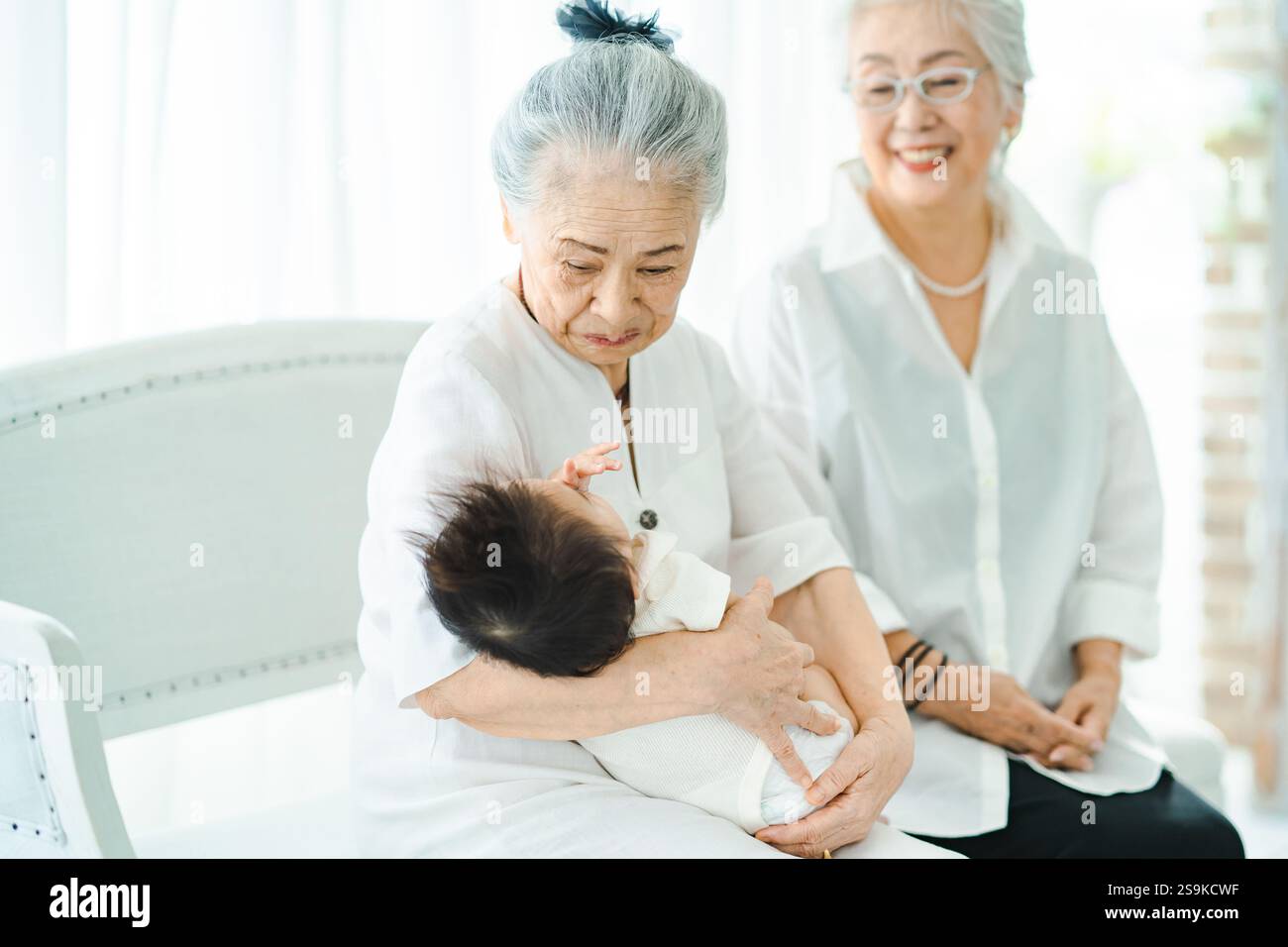 Senior women carrying babies Stock Photo - Alamy