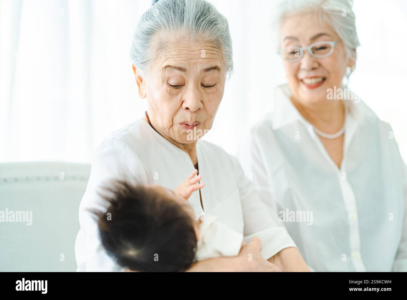 Senior women carrying babies Stock Photo - Alamy