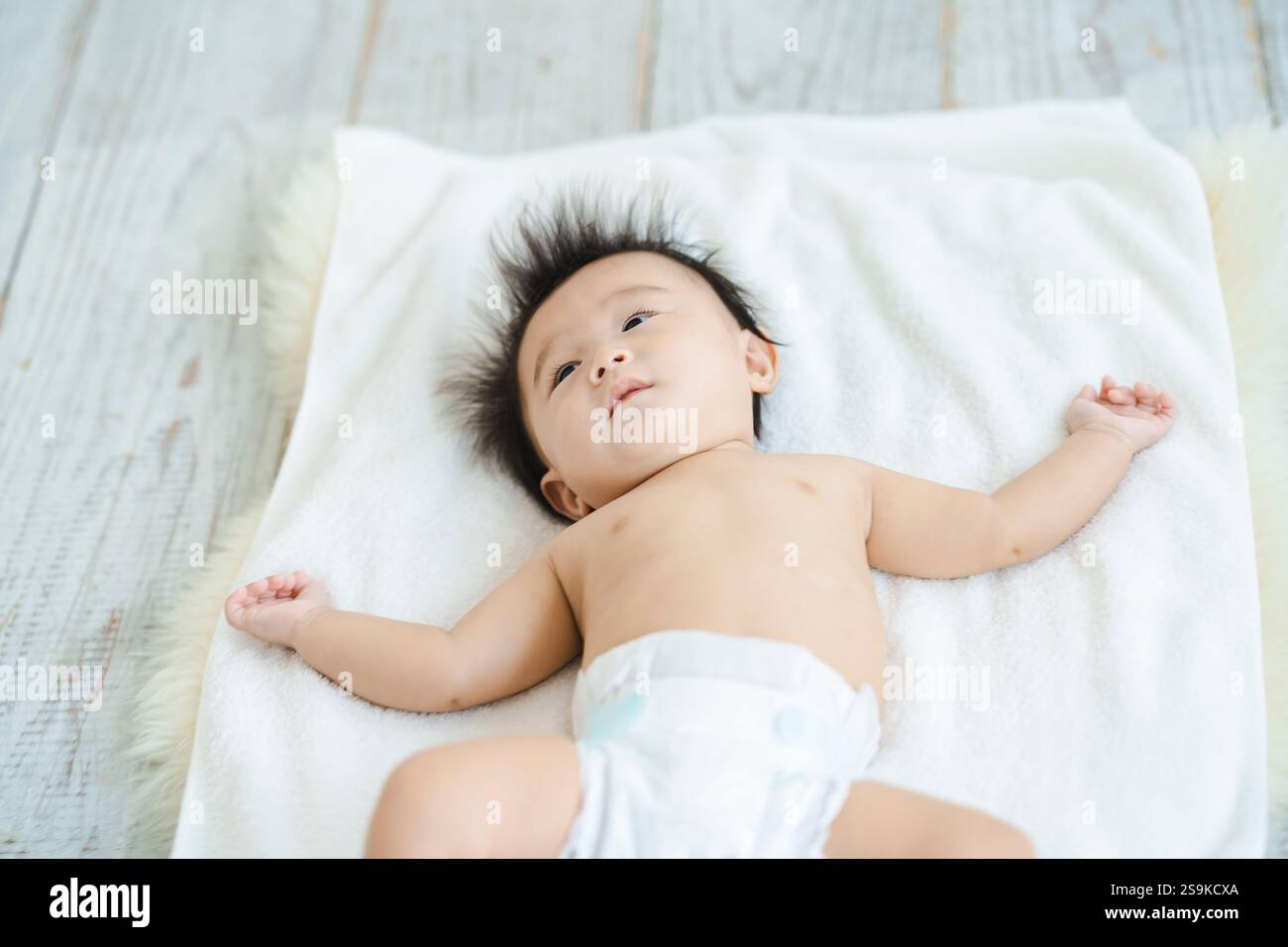 Baby lying on her back Stock Photo - Alamy