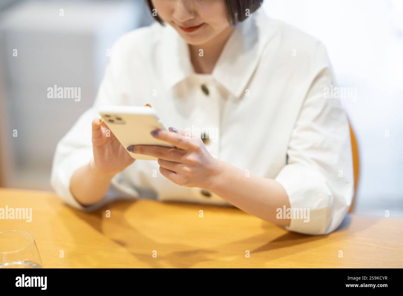 Woman operating smartphone in room Stock Photo - Alamy