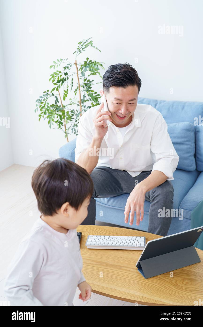 Child interrupting father teleworking Stock Photo - Alamy