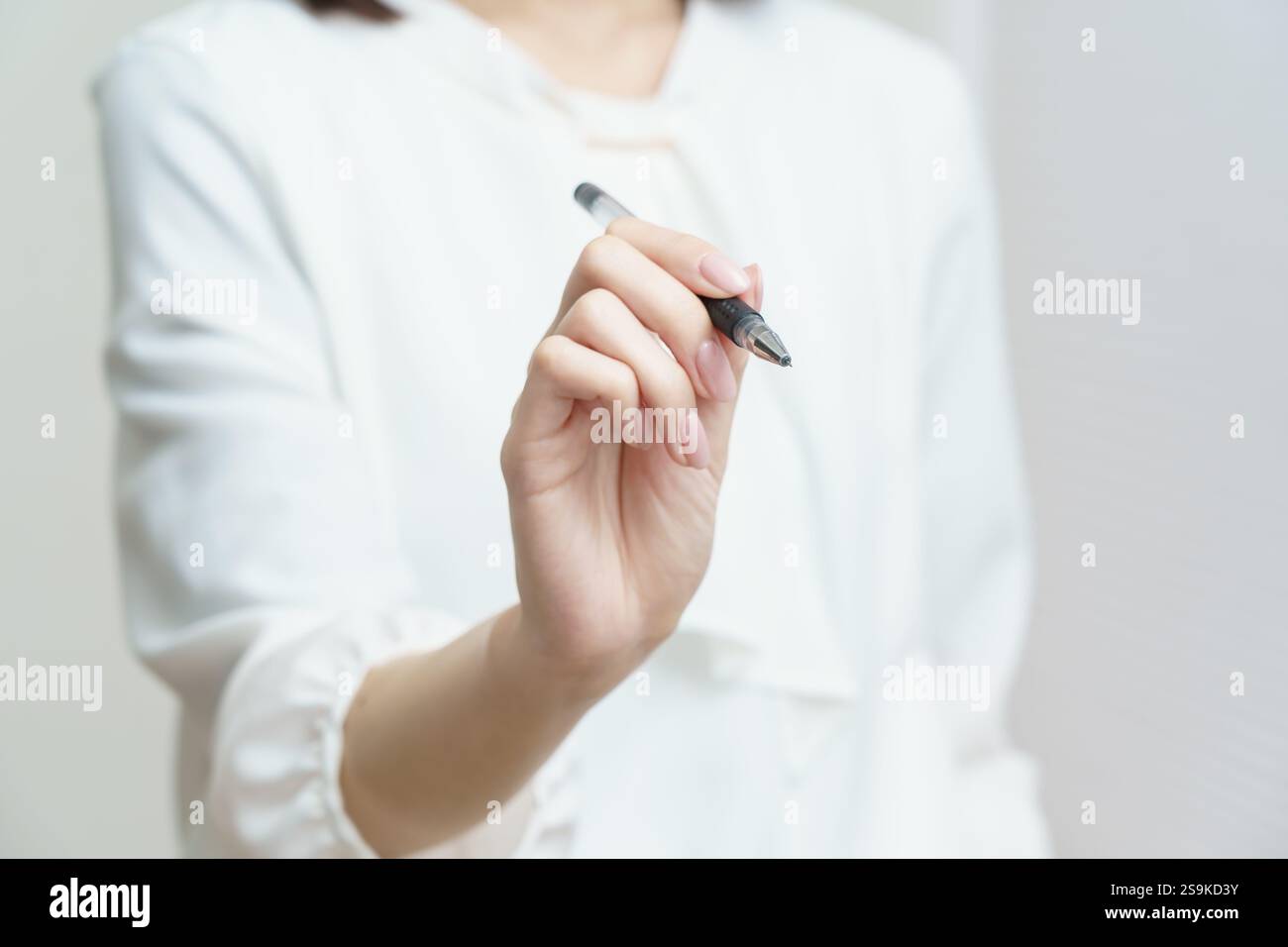 Hand holding ballpoint pen Stock Photo - Alamy