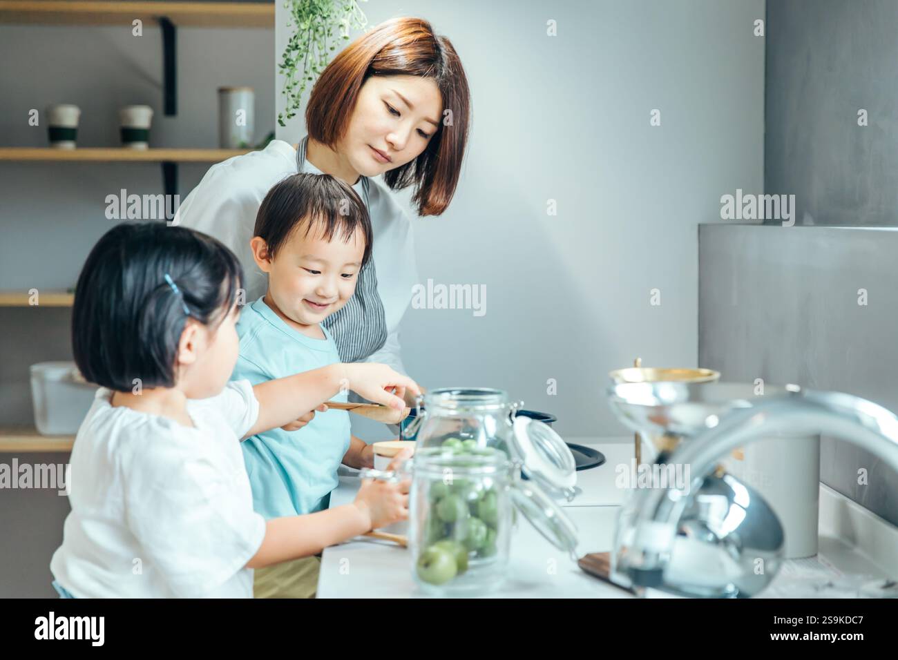 Parent and child cooking in kitchen Stock Photo - Alamy