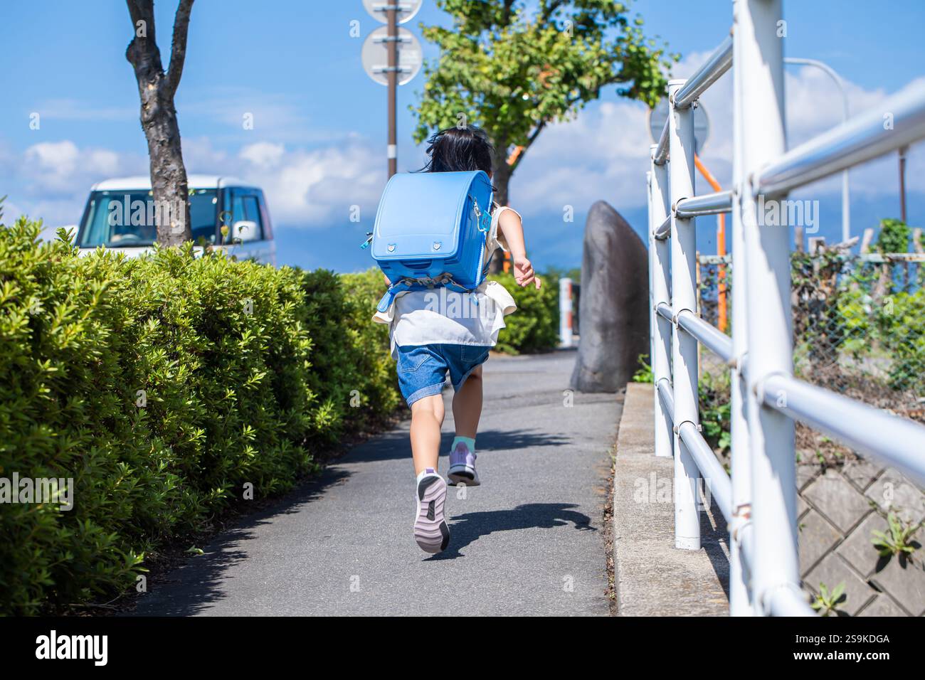 Girl Carrying a School Bag Running Stock Photo - Alamy