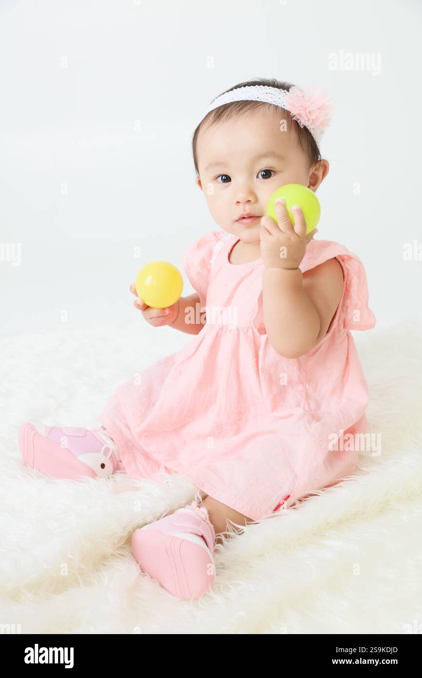 Baby/girl sitting alone Stock Photo - Alamy