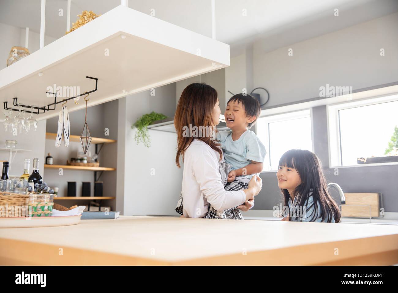 Mother carrying child / hug Stock Photo - Alamy