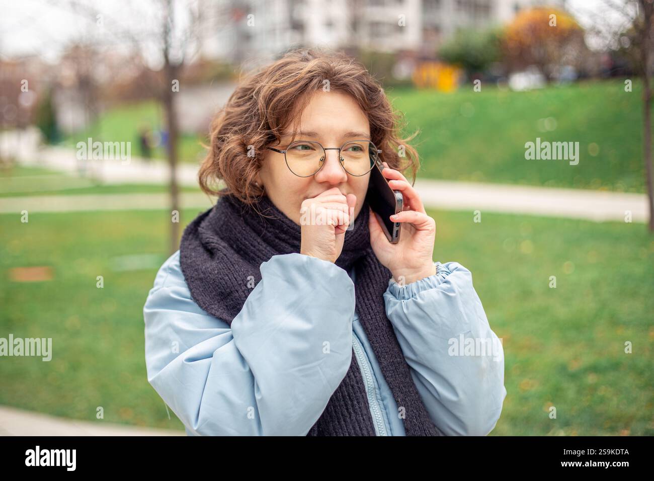 Freezing woman. A young beautiful frozen girl suffers from cold weather ...