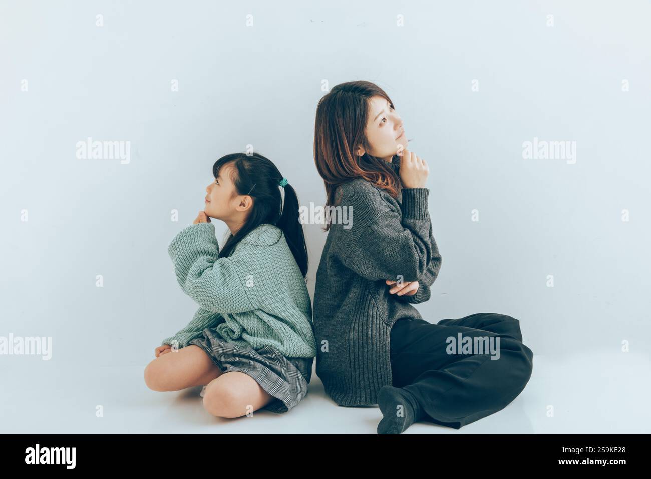 Thinking parents and children Stock Photo - Alamy