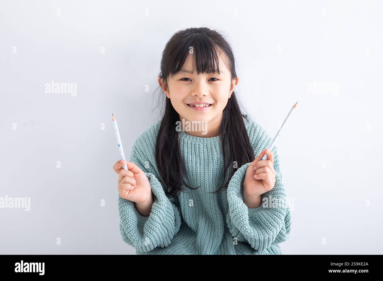 Child holding a pencil Stock Photo - Alamy