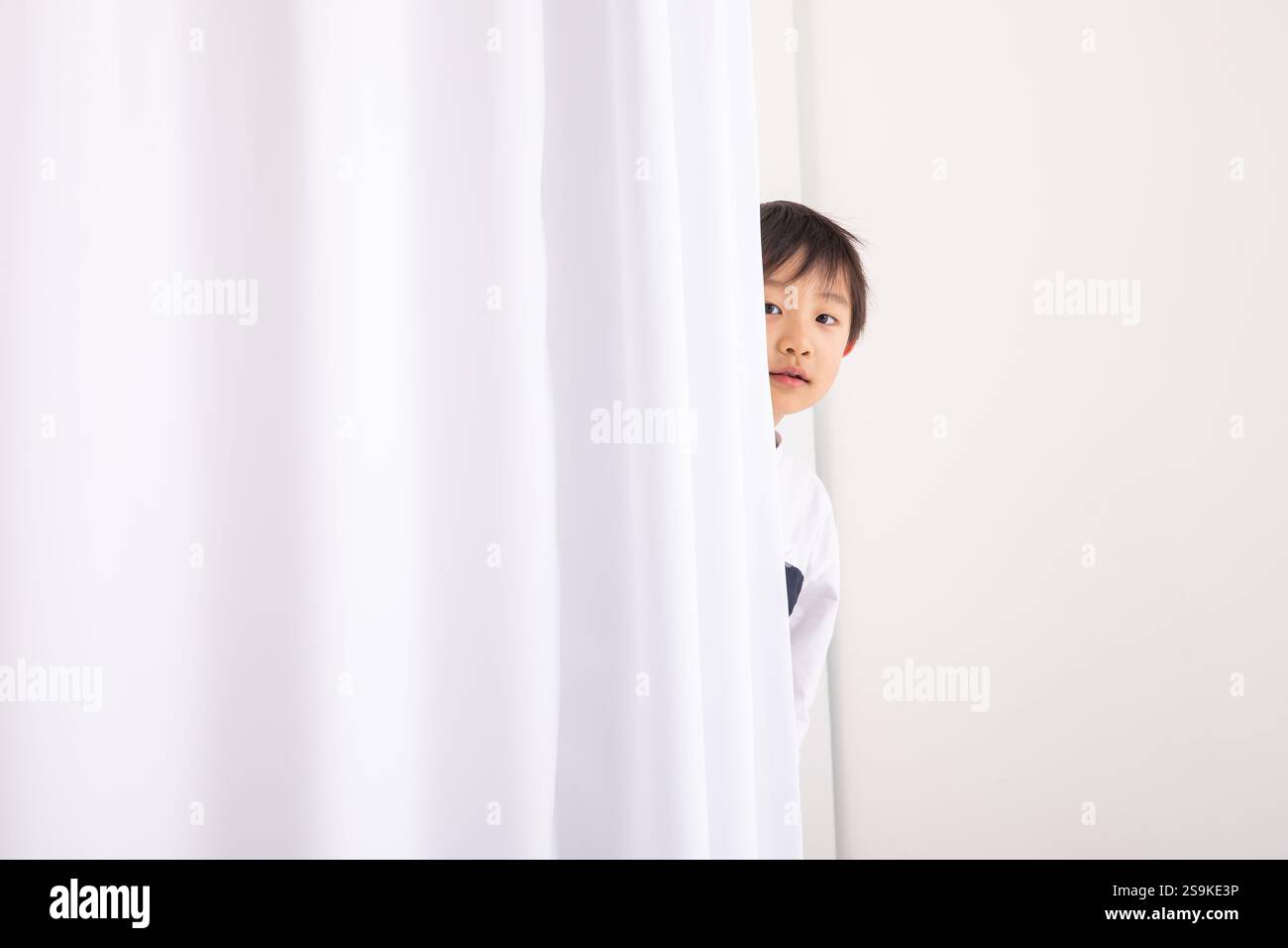 Child sneaking a peek Stock Photo - Alamy