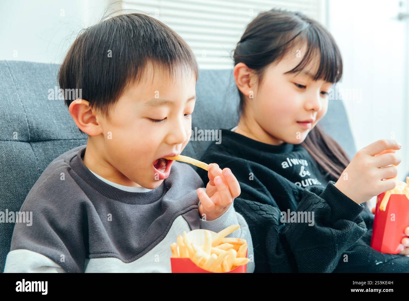 Child eating snack Stock Photo - Alamy