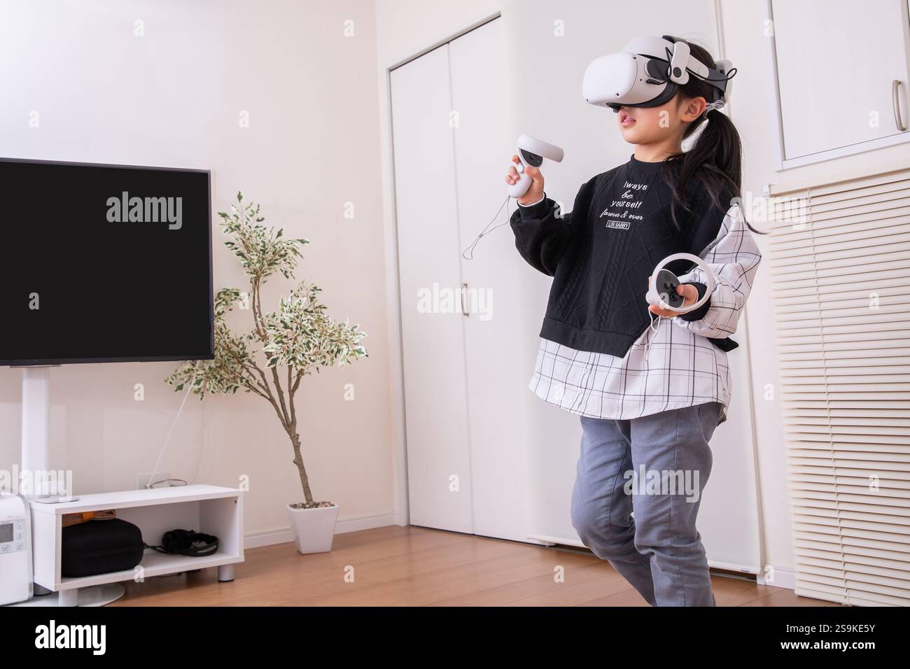 Child playing virtual game Stock Photo - Alamy