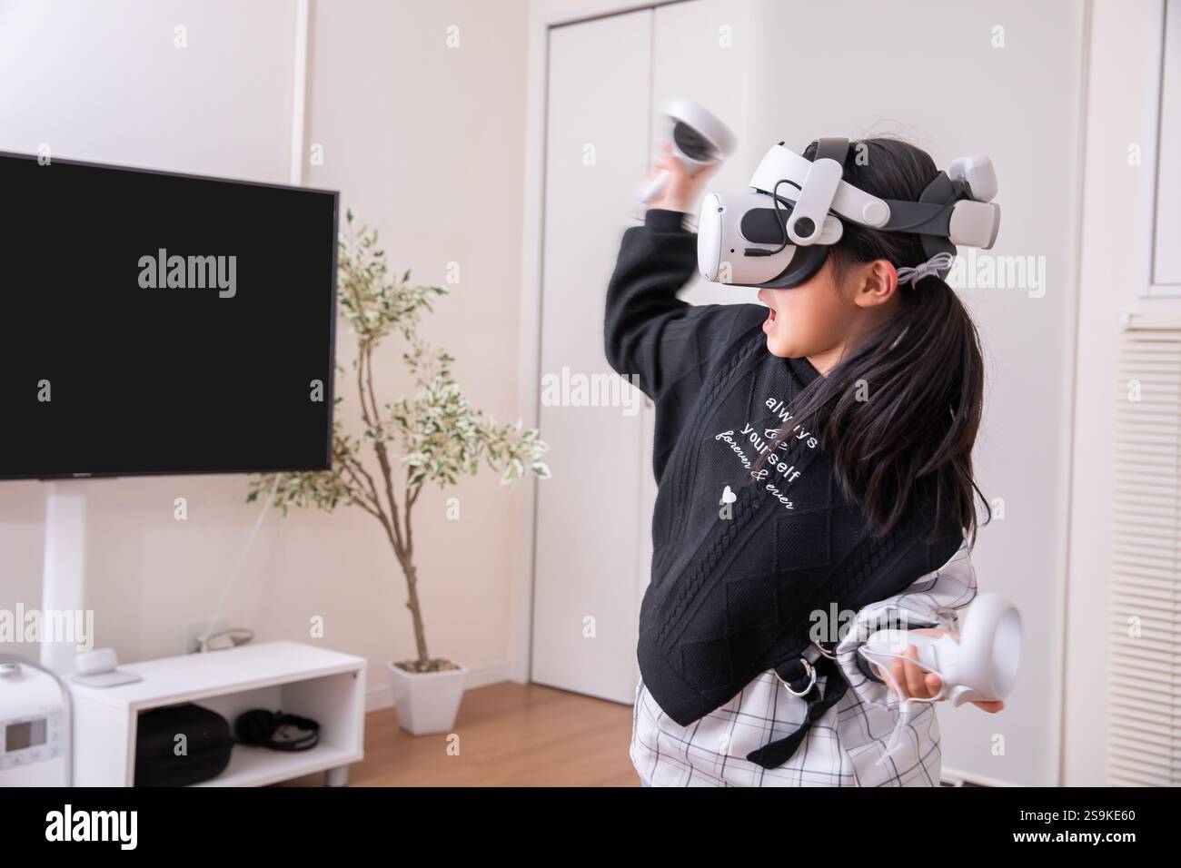 Girl boxing in VR game Stock Photo - Alamy