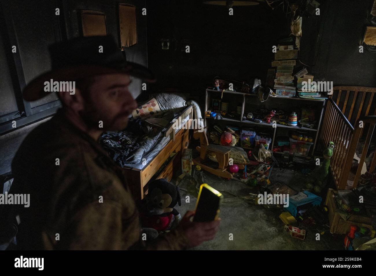 Igor Abramovich surveys heavy damage to a children's room in a house ...