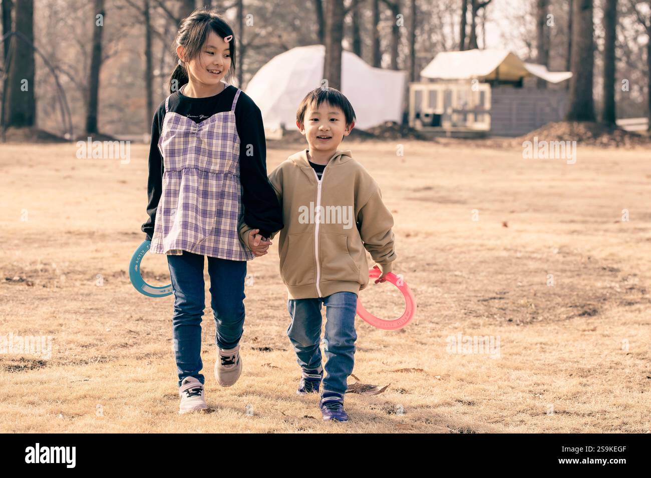 Children walking hand in hand Stock Photo - Alamy
