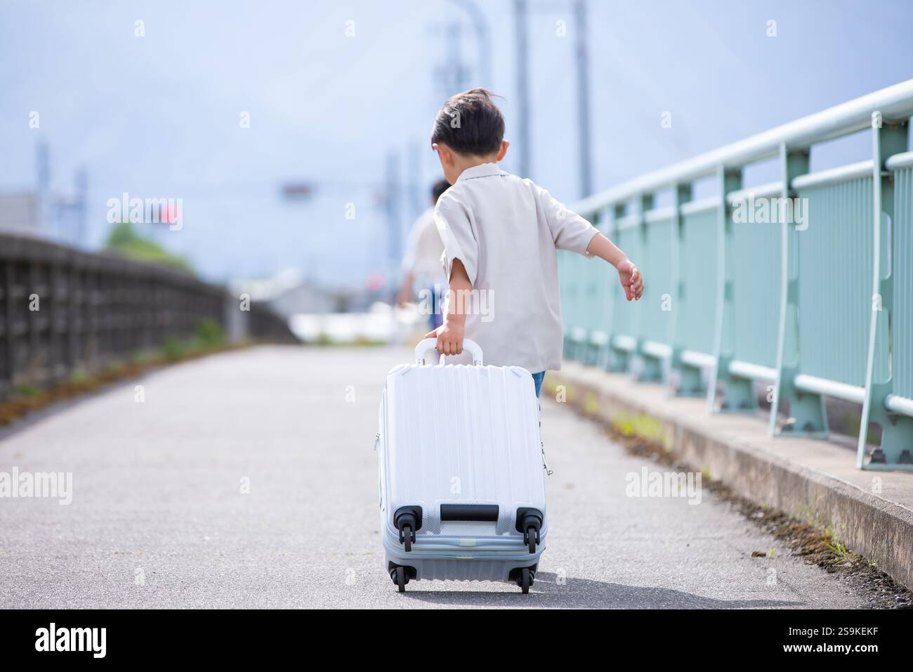 Boy pulling suitcase travel Stock Photo - Alamy