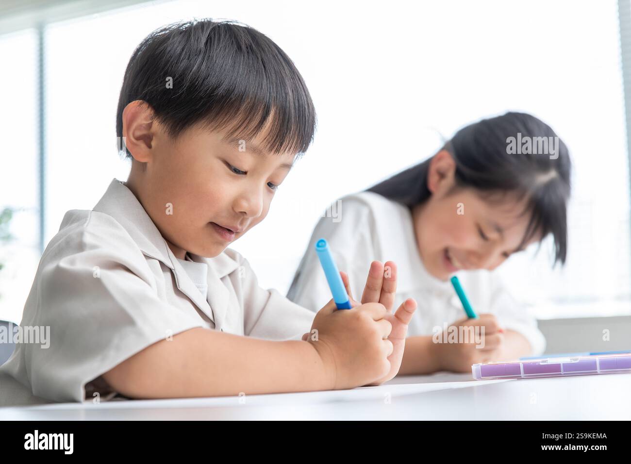 Primary schools student doing homework Stock Photo - Alamy