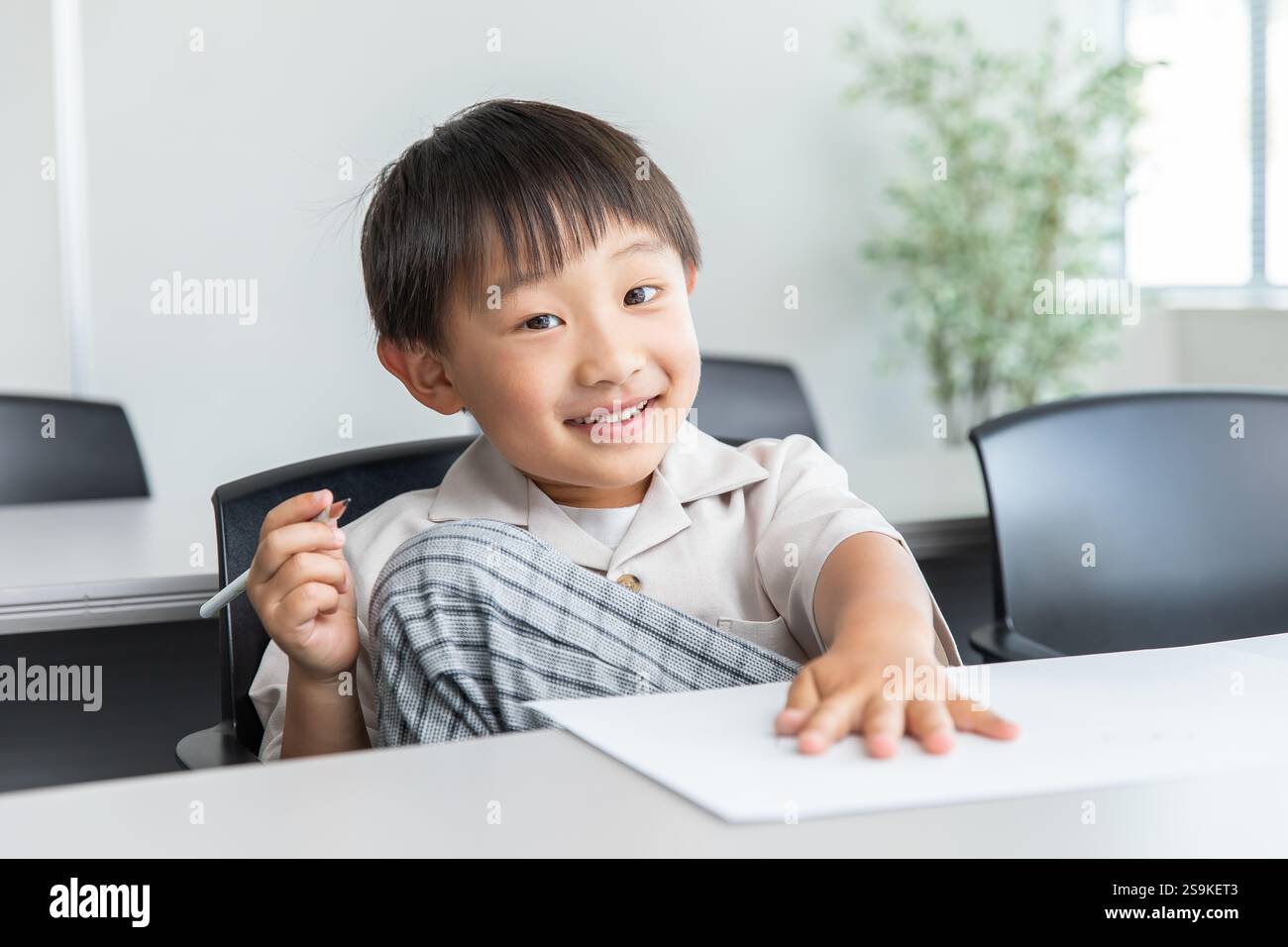 Child having fun learning in the classroom Stock Photo - Alamy