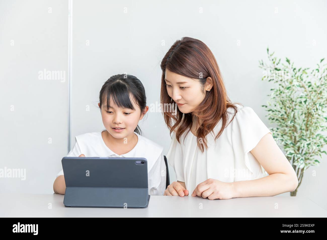Student and teacher learning on tablet Stock Photo - Alamy