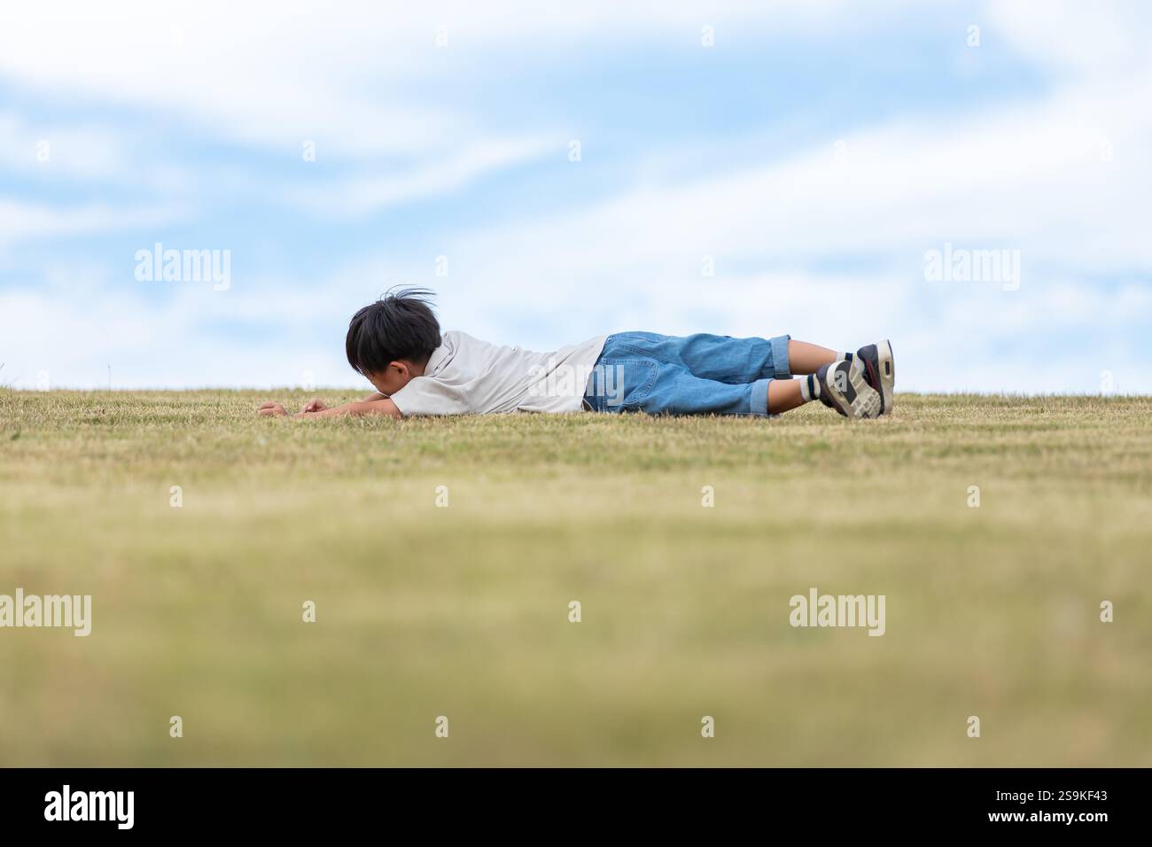 Child rolling on lawn Stock Photo - Alamy