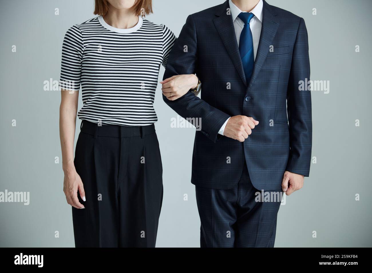 Couple crossing their arms Stock Photo - Alamy